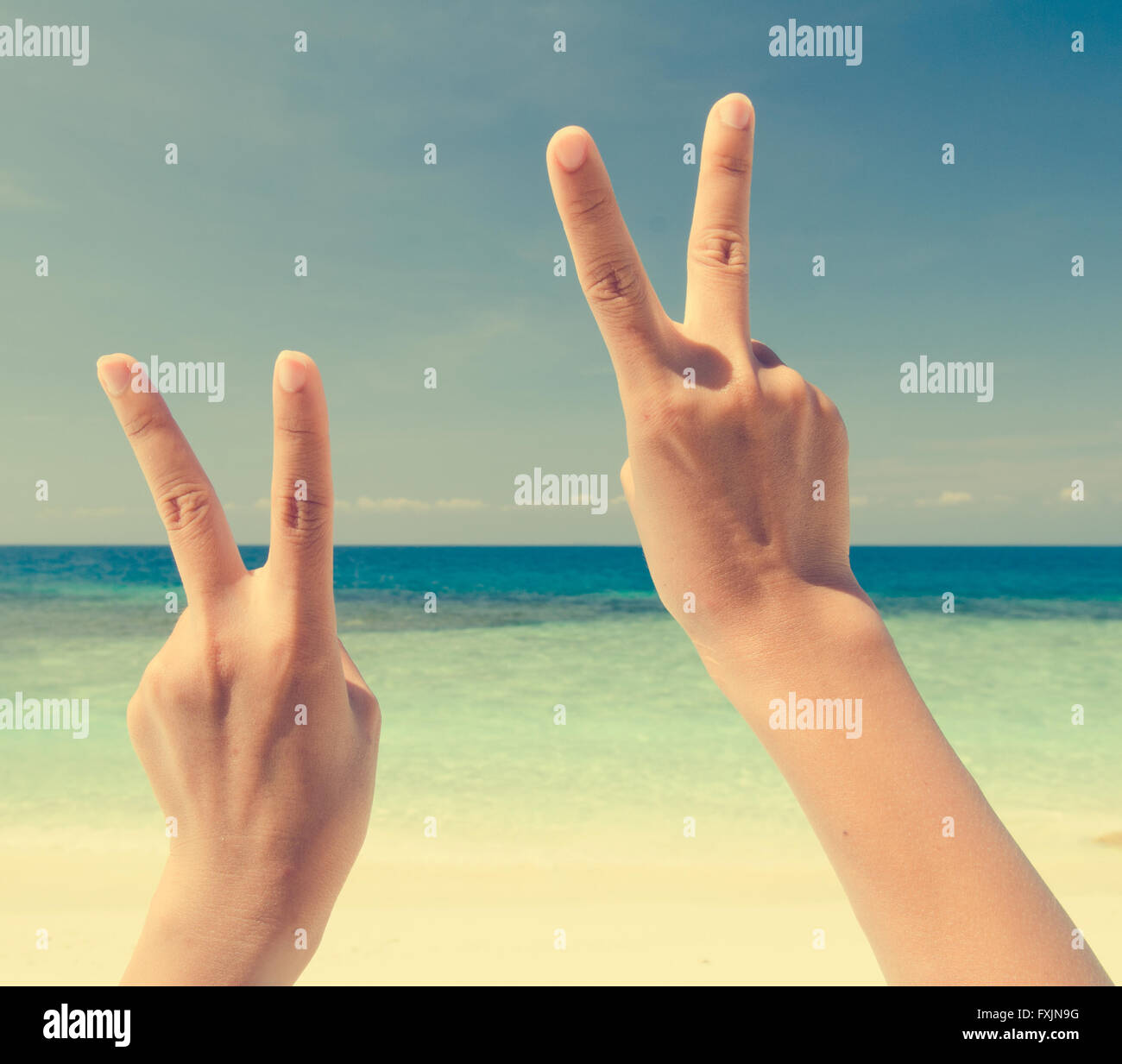 peace sign over beach in vintage retro tone Stock Photo - Alamy