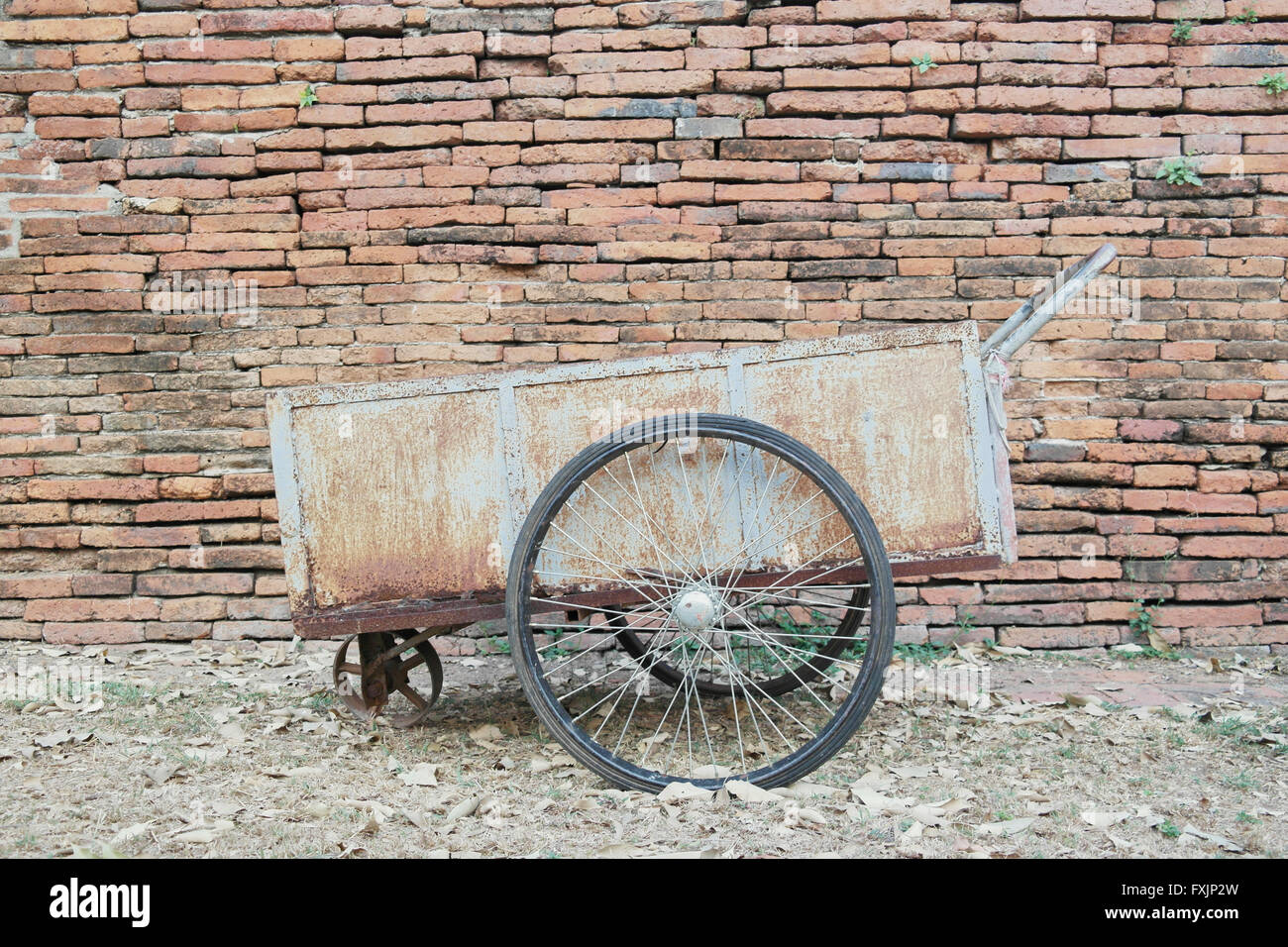 Old Wheelbarrow stand in front of a wall Stock Photo - Alamy