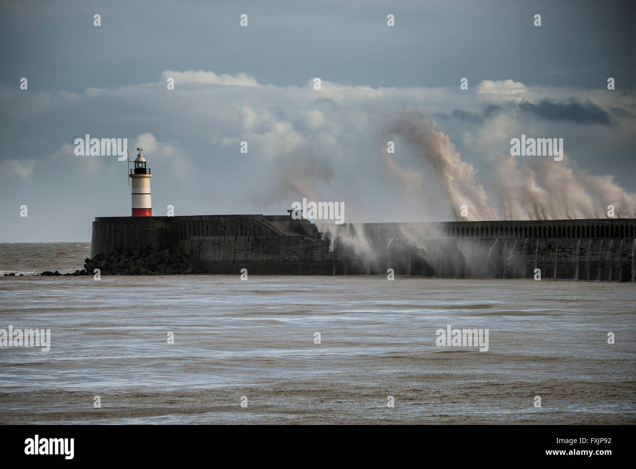 Huge sea waves crashing over lighthouse during storm with beautiful ...