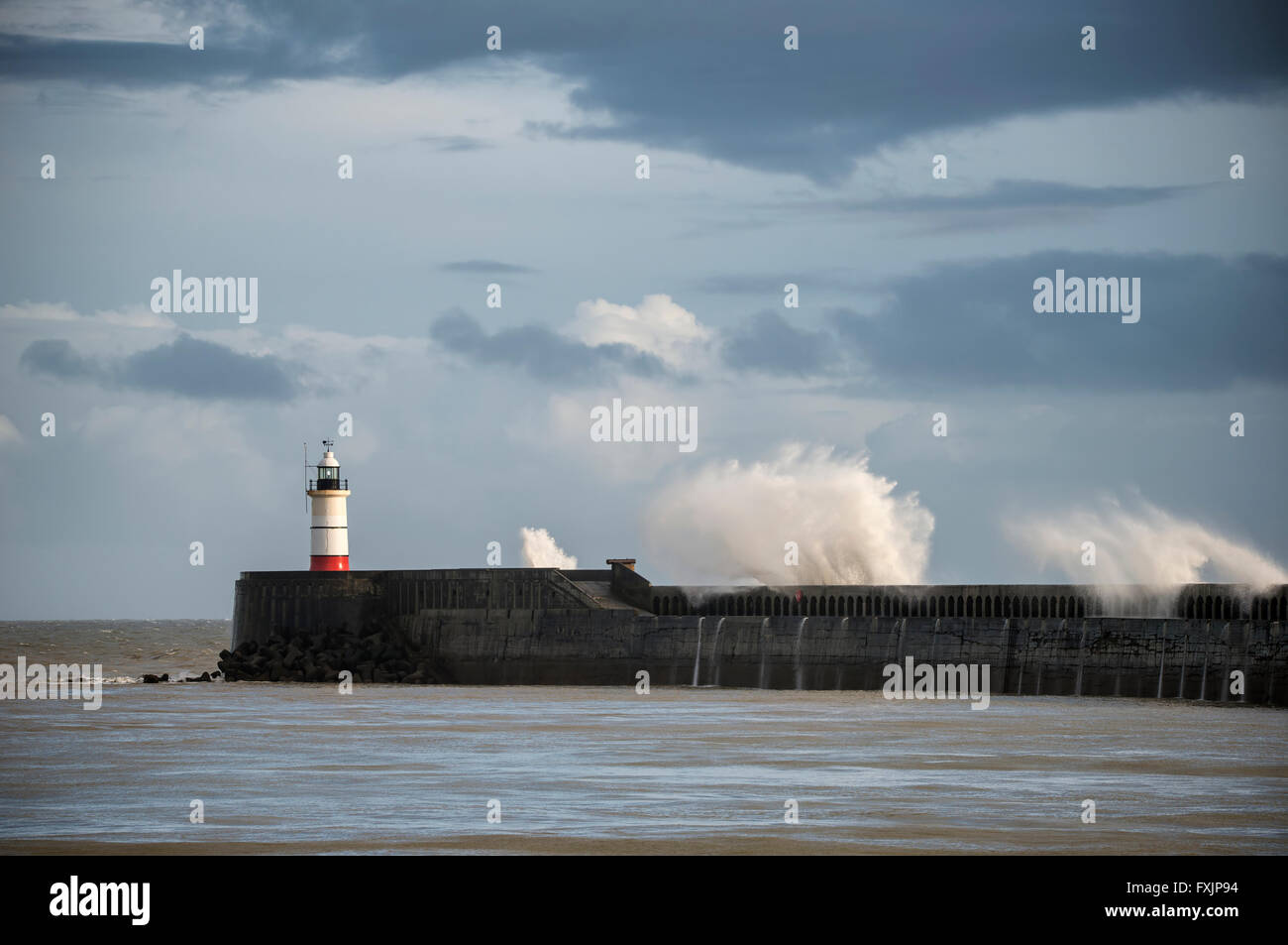 Huge sea waves crashing over lighthouse during storm with beautiful ...