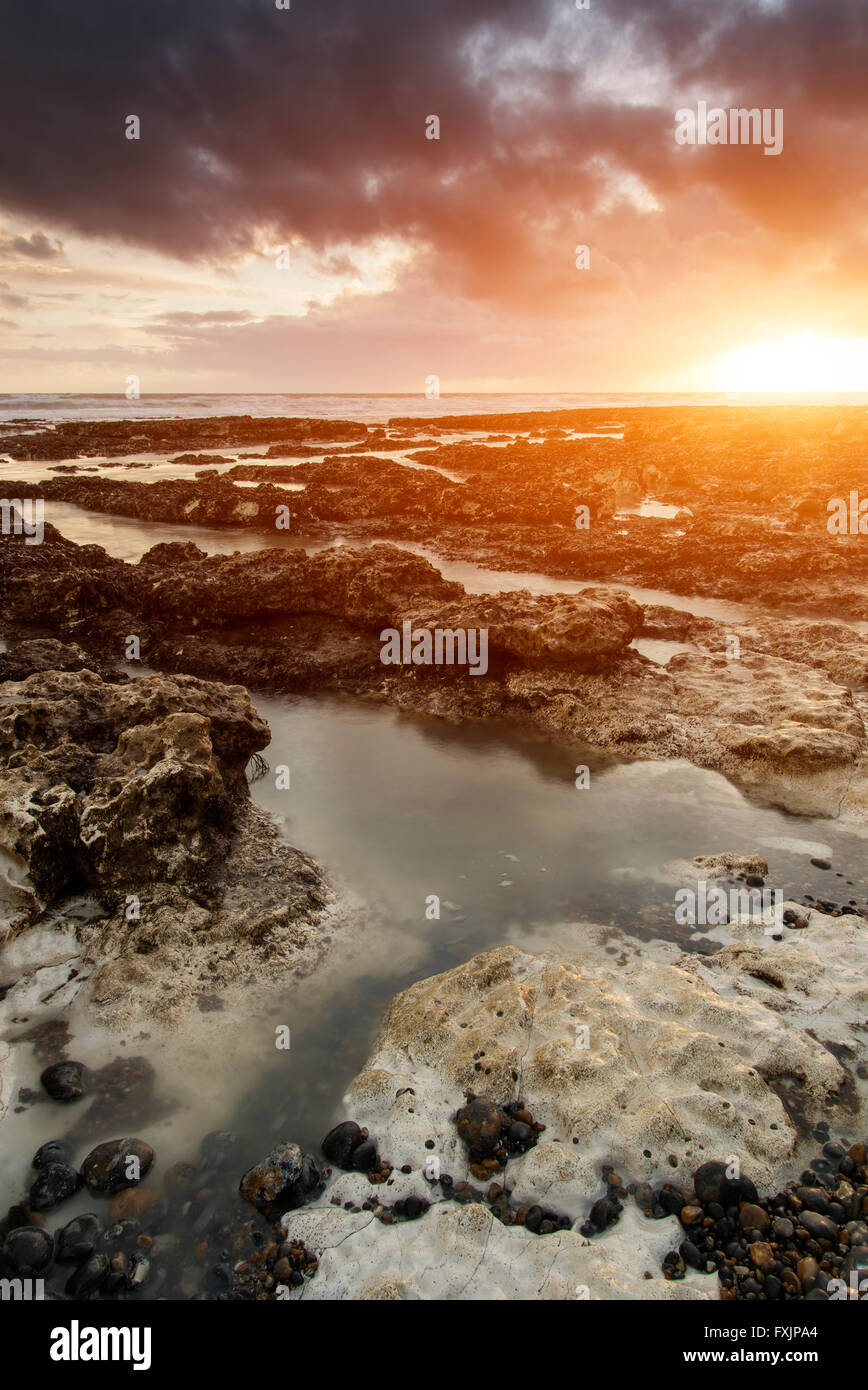 Beautiful rocky beach sunset landscape long exposure Stock Photo - Alamy