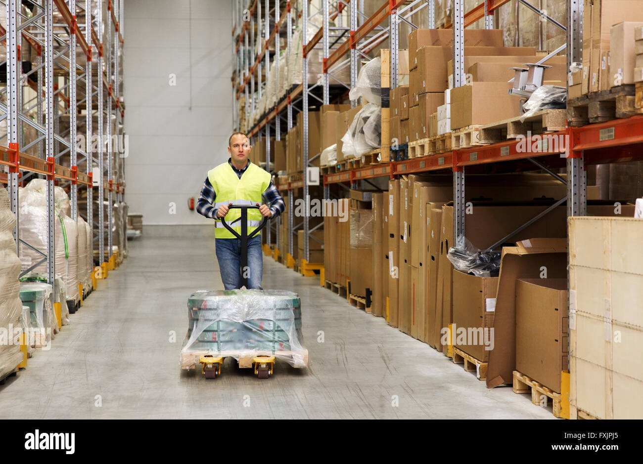 man carrying loader with goods at warehouse Stock Photo - Alamy