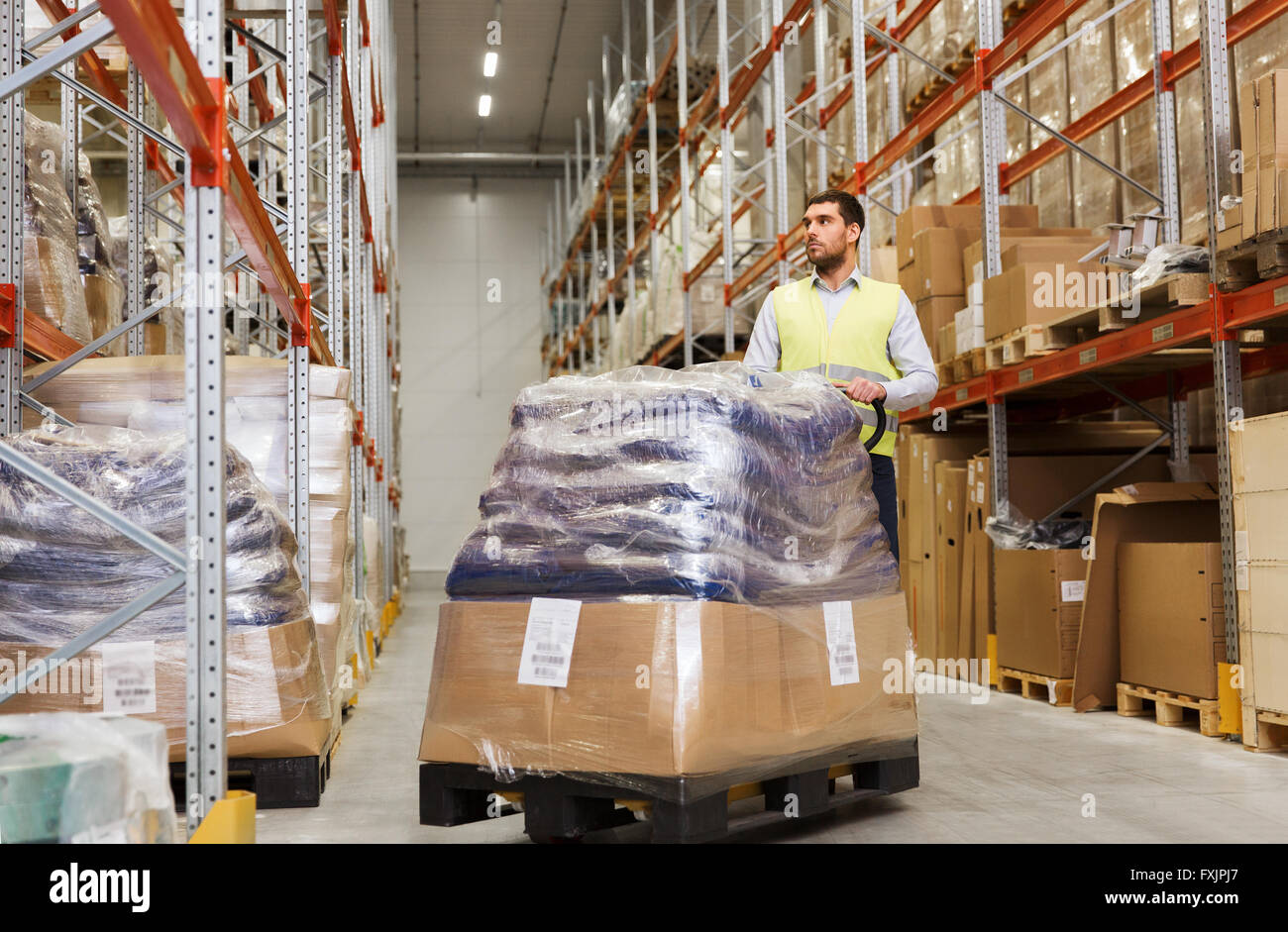 man carrying loader with goods at warehouse Stock Photo - Alamy