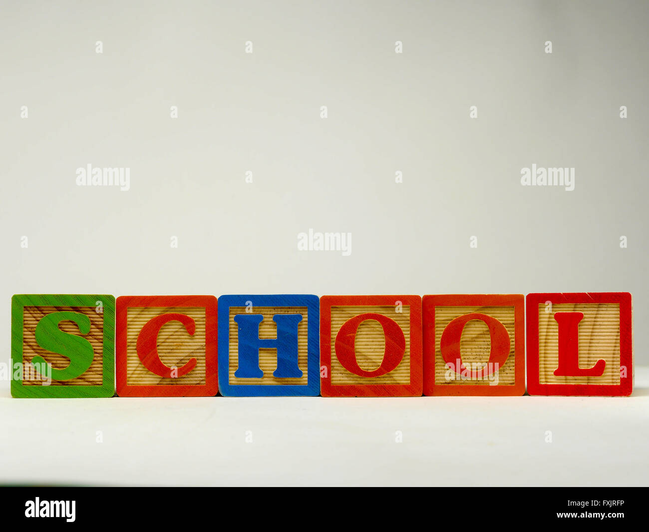 Kid's building blocks spelling the word school Stock Photo - Alamy