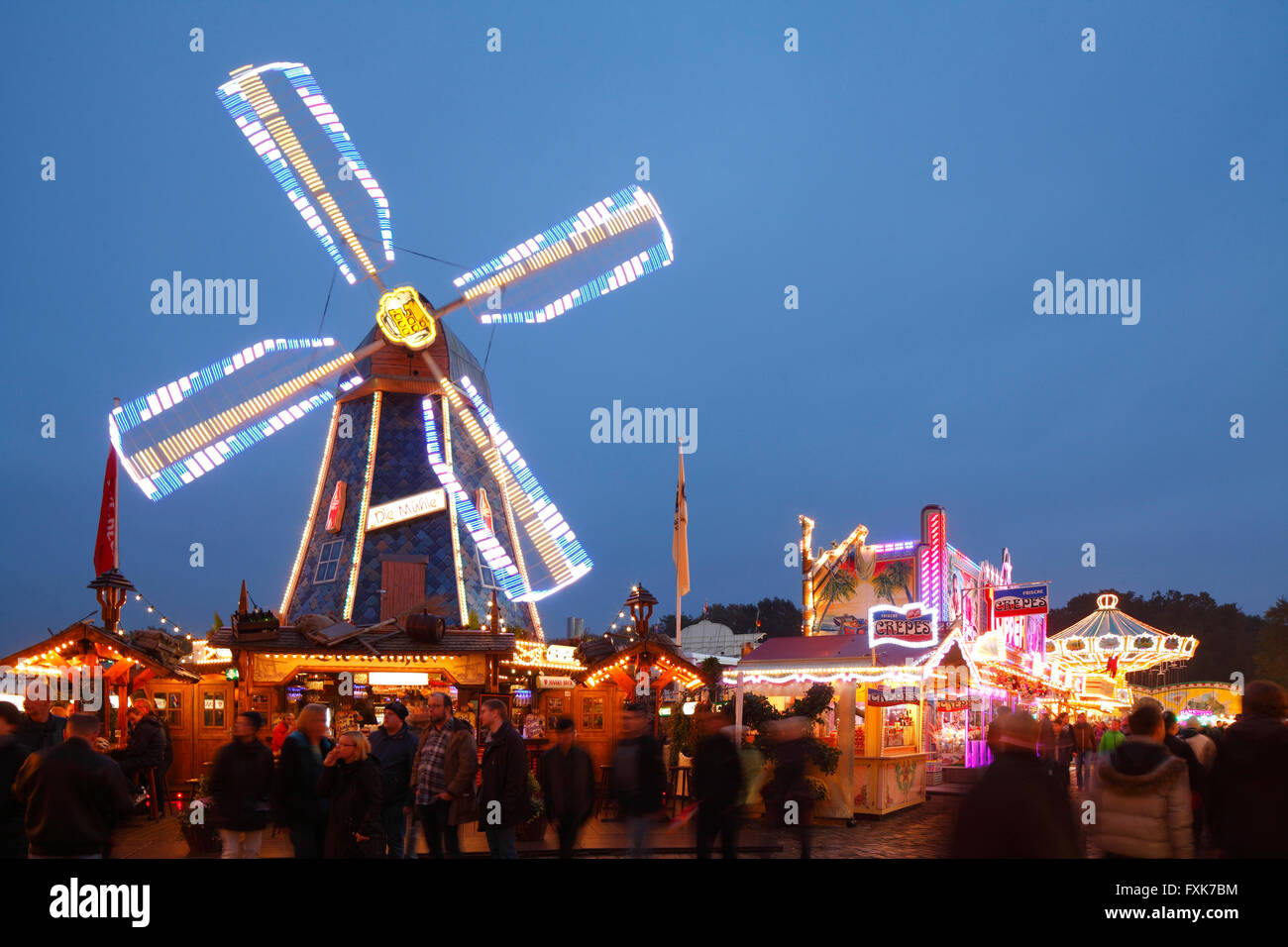 Sweet stall The Mill on the fun fair Bremer Freimarkt at dusk, Bremen ...