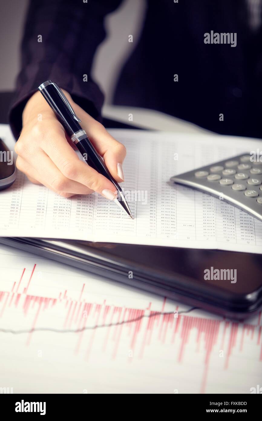 Female hand showing diagram on financial report with pen Stock Photo ...
