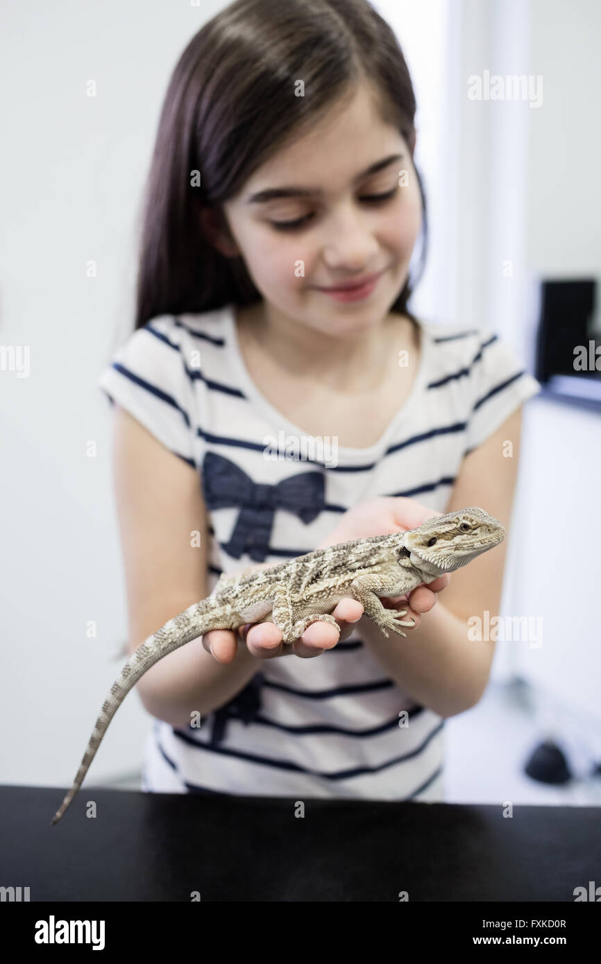 Girl holding her pet lizard in clinic Stock Photo - Alamy