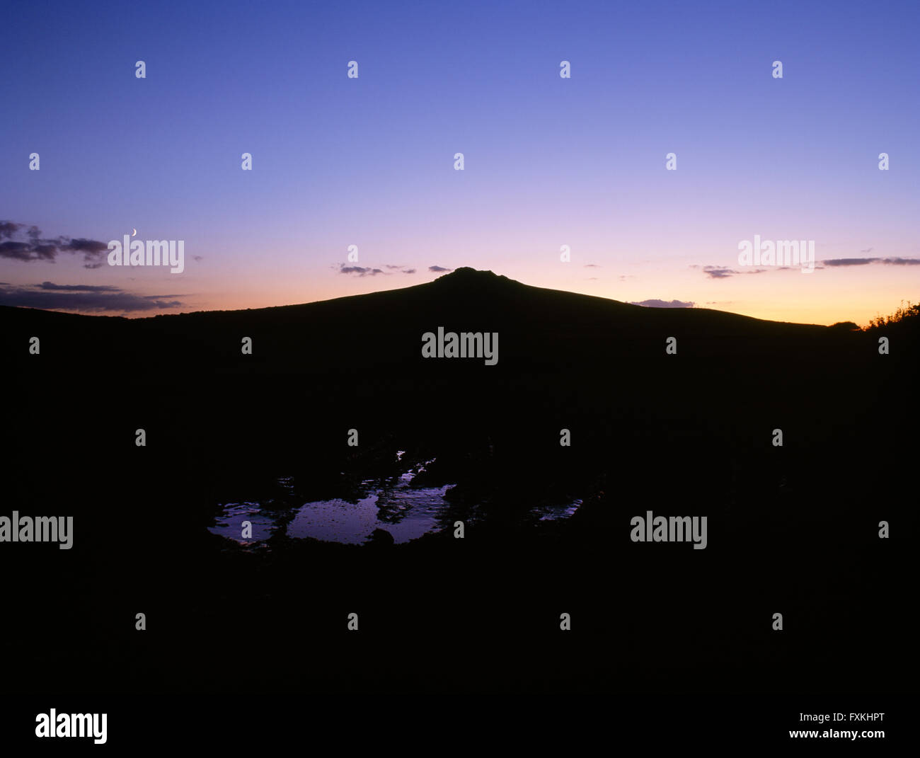 Mynydd Carningli, Pembrokeshire, at twilight with rising sickle moon ...