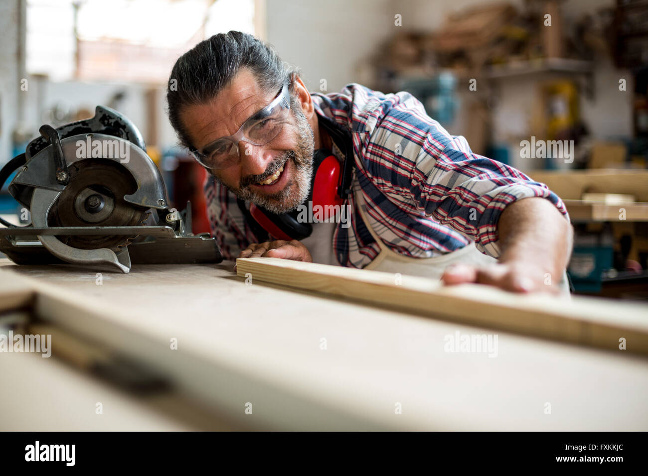 Carpenter measuring wooden plank Stock Photo - Alamy