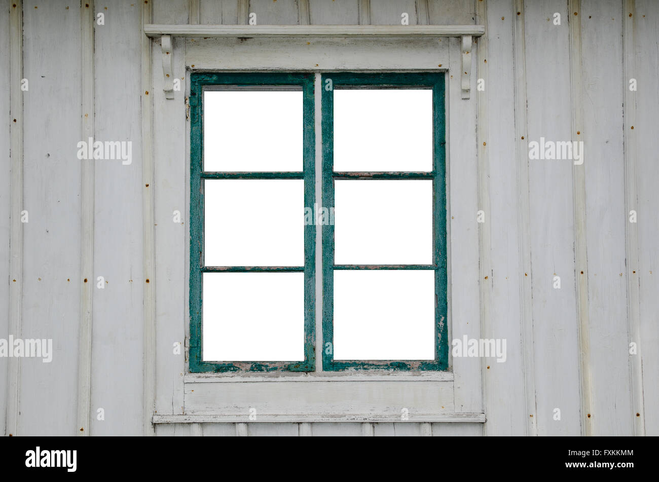 Cut out windowpanes in an old weathered window at a wooden plank facade ...