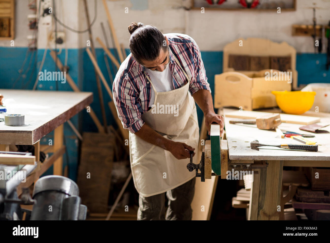 Carpenter working on wooden plank in workbench Stock Photo - Alamy