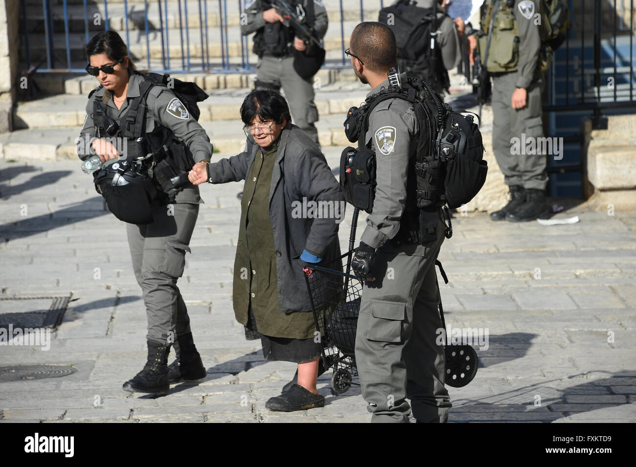 Jerusalem, Israel. 07th Apr, 2016. Armed security guards help an older ...