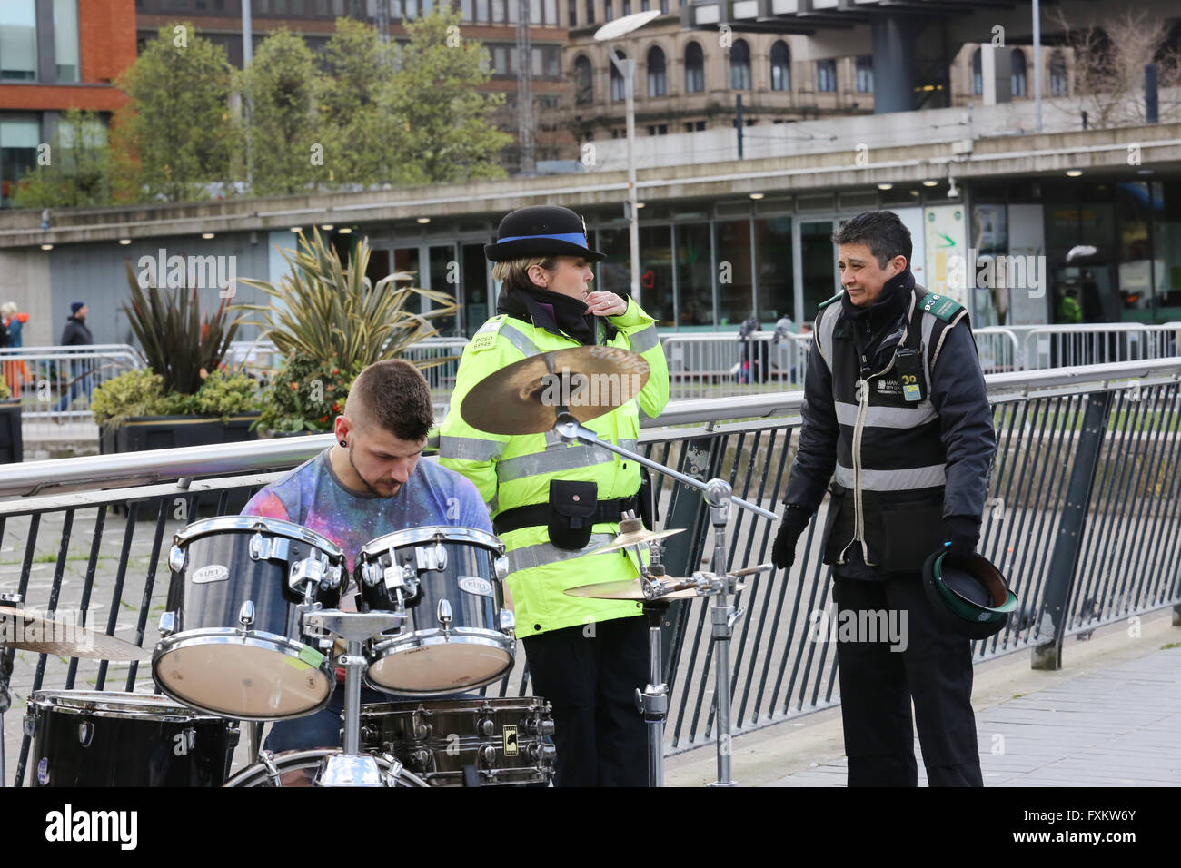 A PCSO and Environmental Officer standing next to a busking drummer in ...