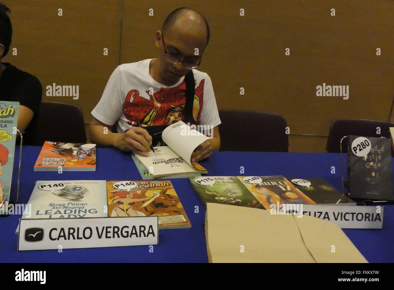 Pasig, Philippines. 16th Apr, 2016. Carlo Vergara signs a graphic novel ...