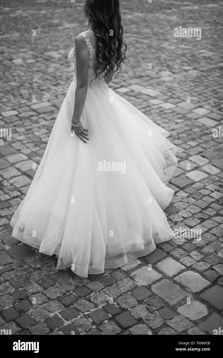 Close up of dreamy beautiful brunet bride walking alone in the park ...