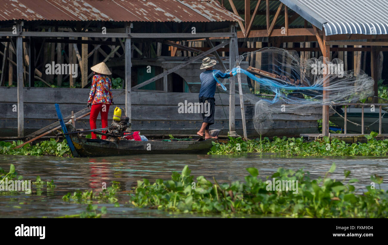 Man throwing fishing net into water hi-res stock photography and images ...