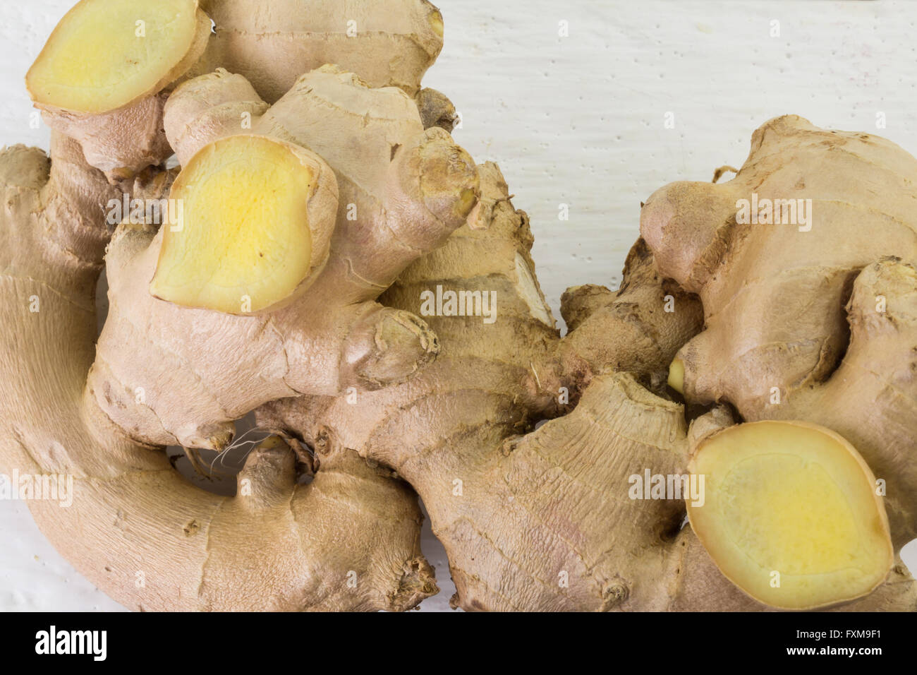 Whole ginger root and cut slices isolated on white Stock Photo - Alamy