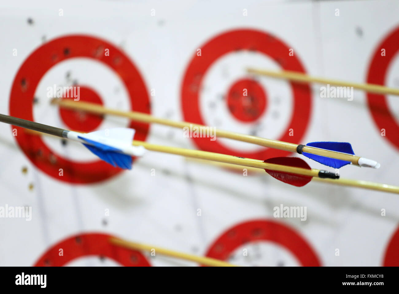 Red targets with colorful arrows. Shallow depth of fields Stock Photo ...