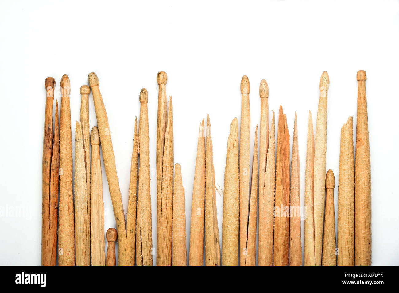 Range of mixed old broken used wooden drumsticks on white background ...