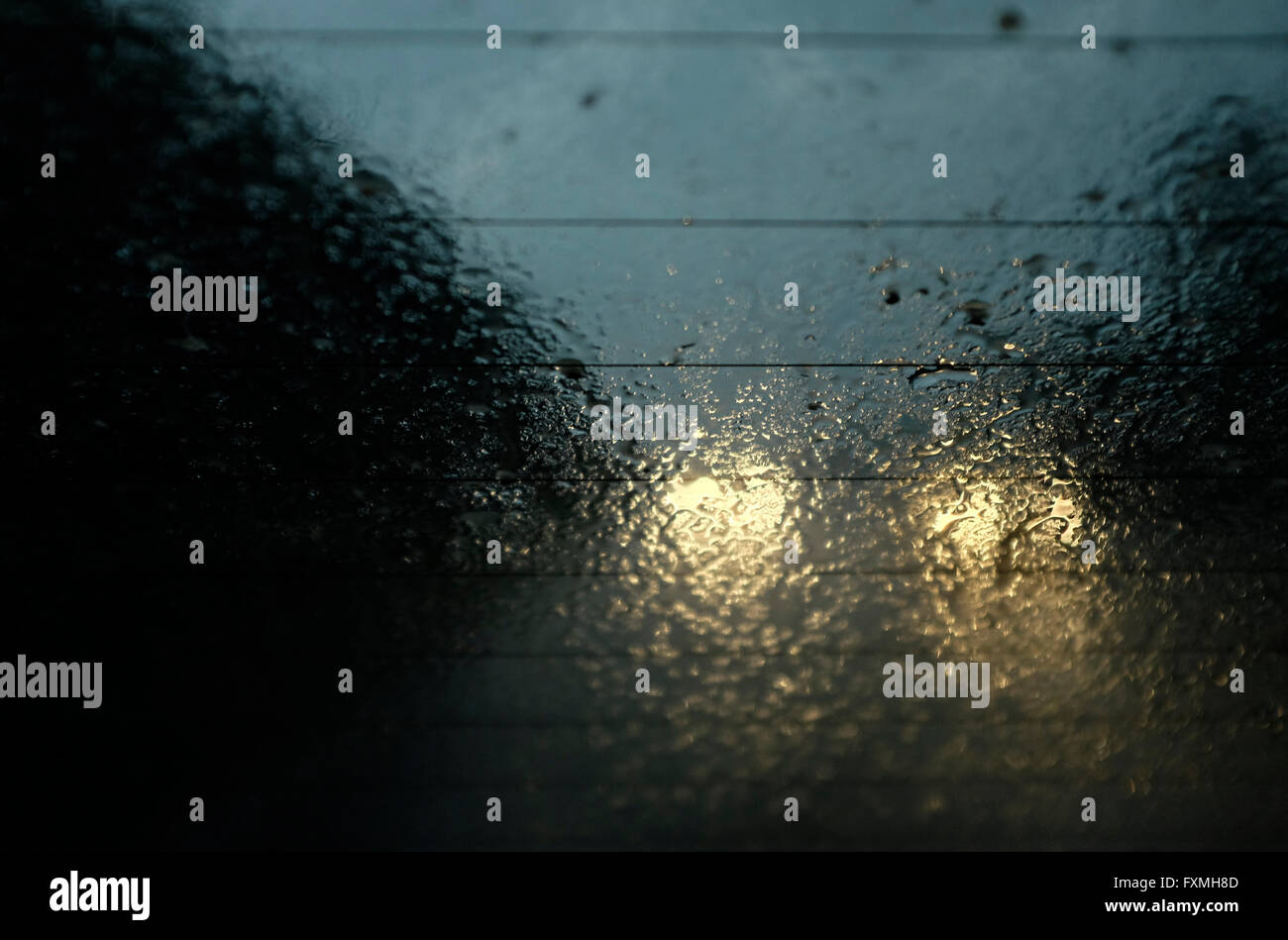 Reflection of car lights on car window during rain at night Stock Photo ...