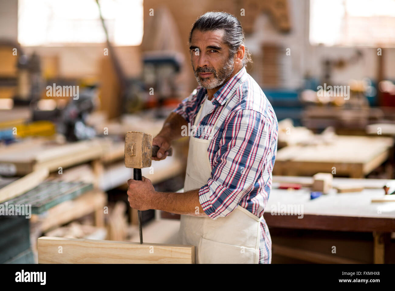 Carpenter using mallet and chisel Stock Photo - Alamy