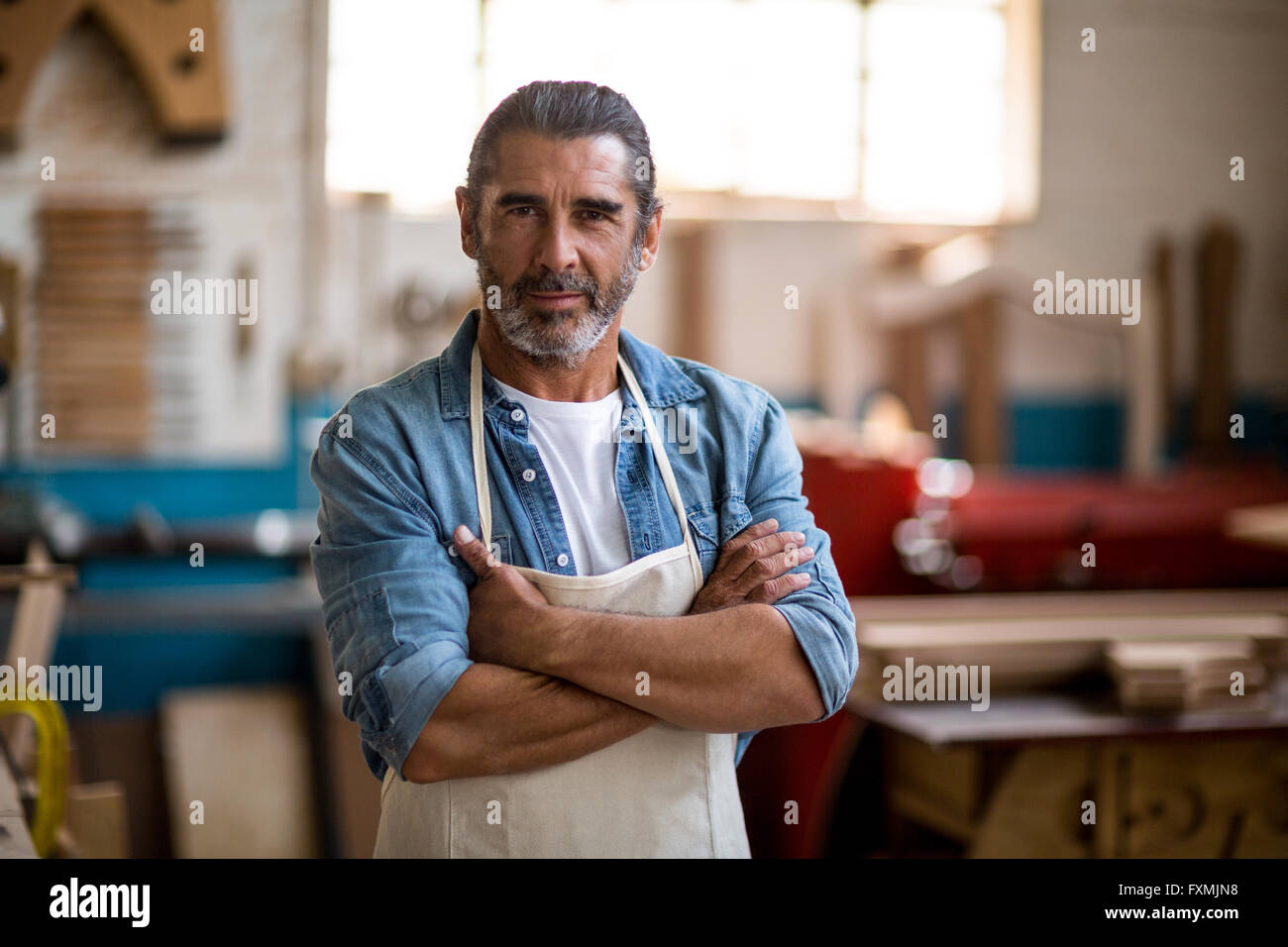 Portrait of carpenter standing with arms crossed Stock Photo - Alamy