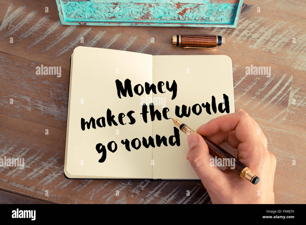Retro effect and toned image of a woman hand writing on a notebook ...