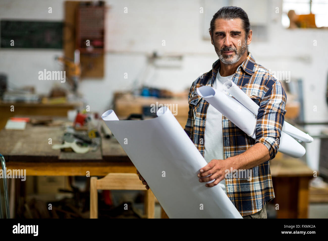 Portrait of carpenter with blueprint Stock Photo - Alamy