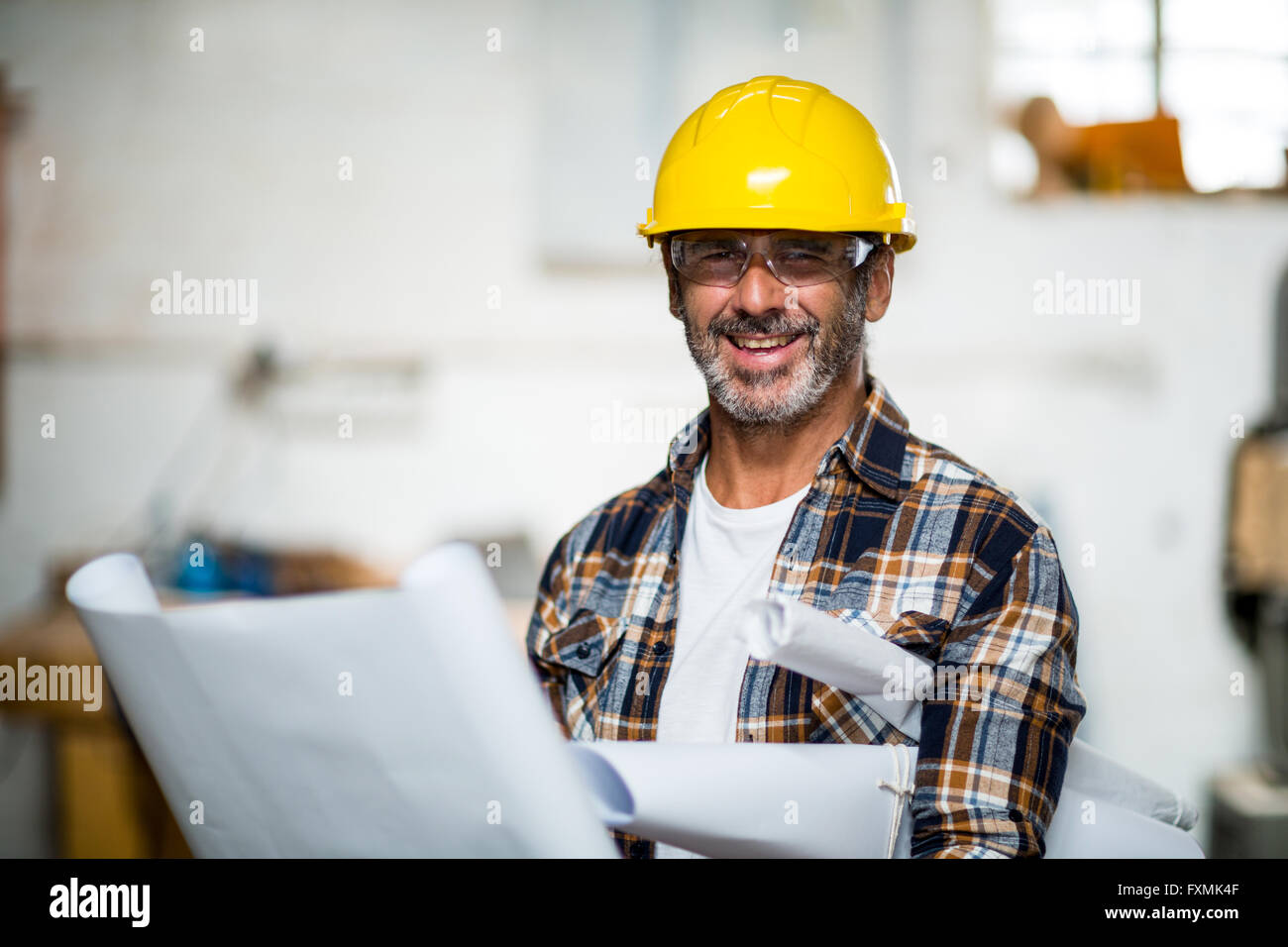Portrait of carpenter with blueprint Stock Photo - Alamy