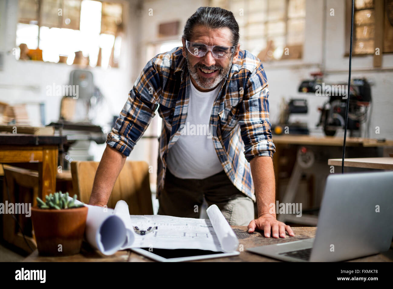 Portrait of carpenter with blueprint Stock Photo - Alamy