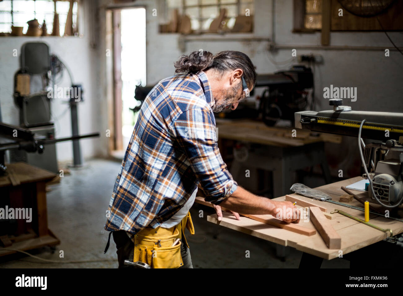 Carpenter marking on wooden plank with pencil Stock Photo - Alamy