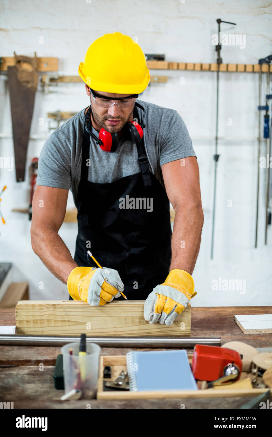 Carpenter marking on wooden plank with pencil Stock Photo - Alamy