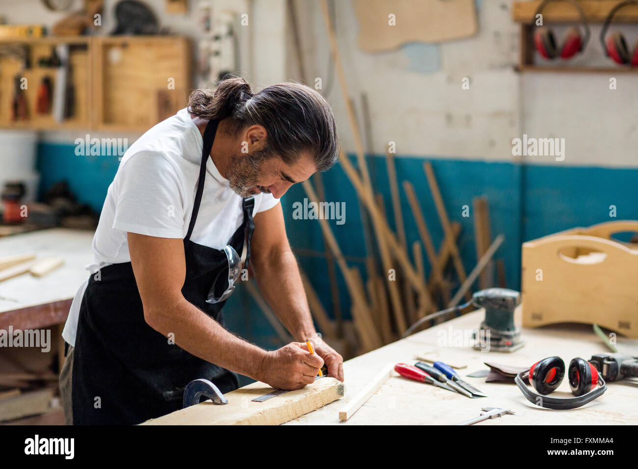 Carpenter marking on wooden plank with pencil Stock Photo - Alamy