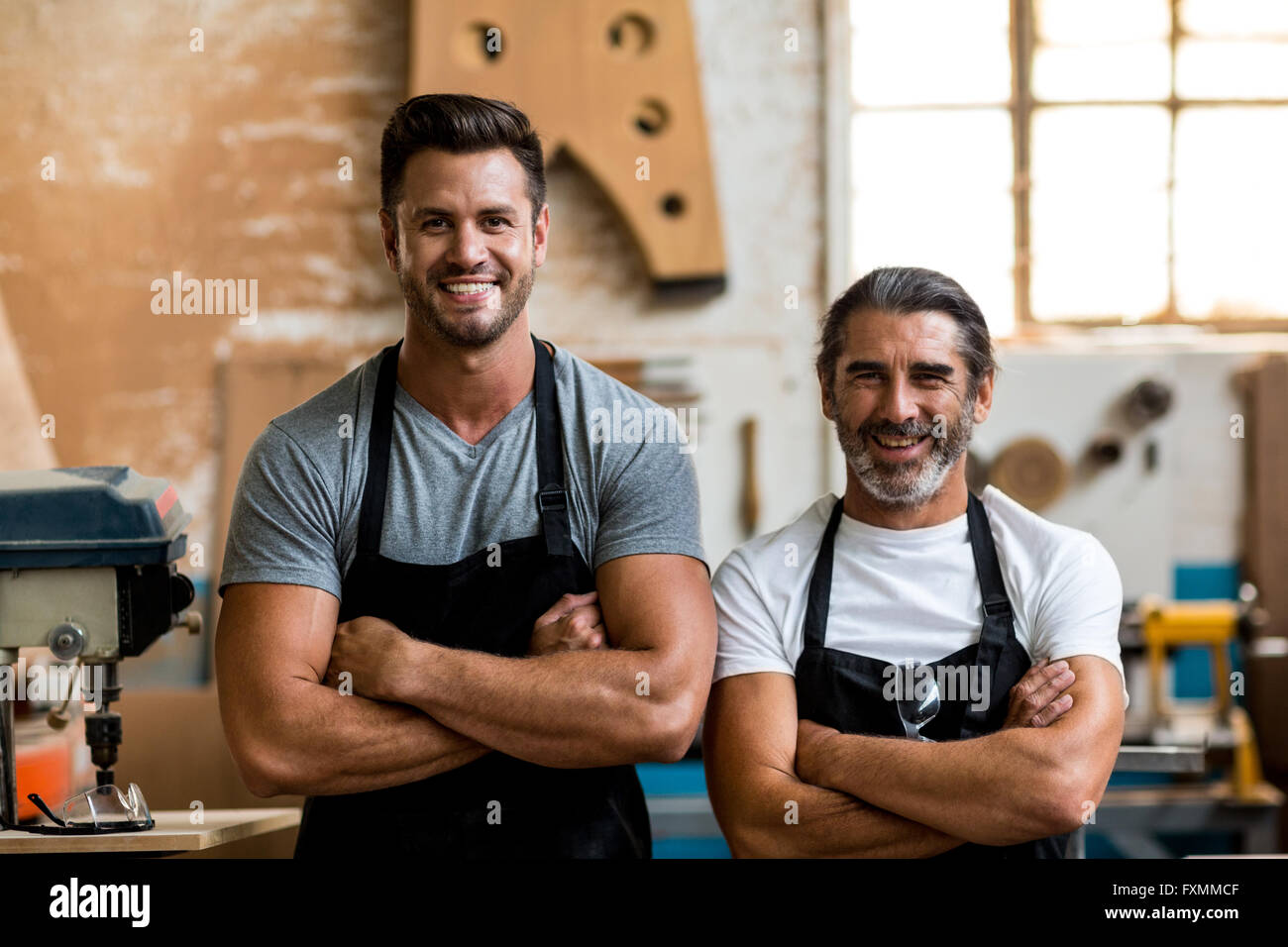Carpenters standing with arms crossed in workshop Stock Photo - Alamy