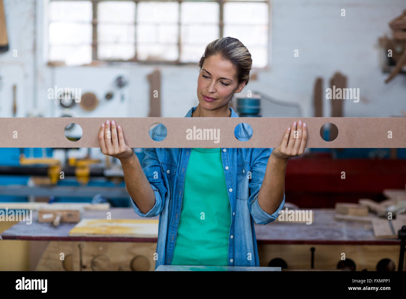 Female carpenter checking a wooden plank Stock Photo - Alamy