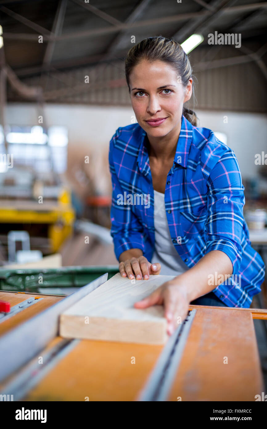 Portrait of female carpenter with wooden plank Stock Photo - Alamy