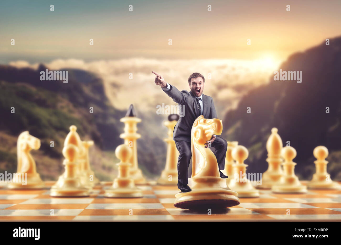 Mad businessman on the knight on the chess board Stock Photo - Alamy