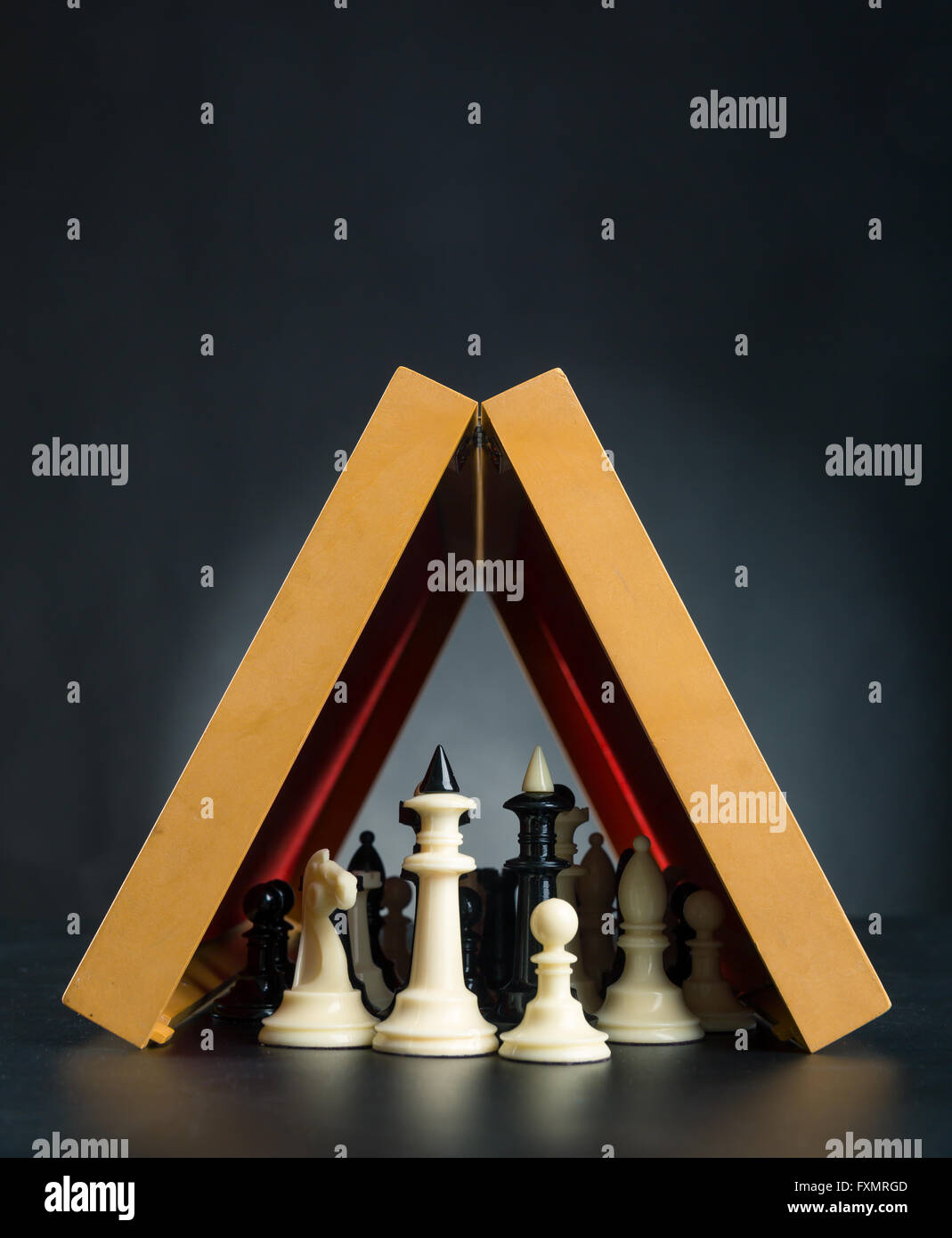 Chess figures standing under the chess board on the table Stock Photo ...