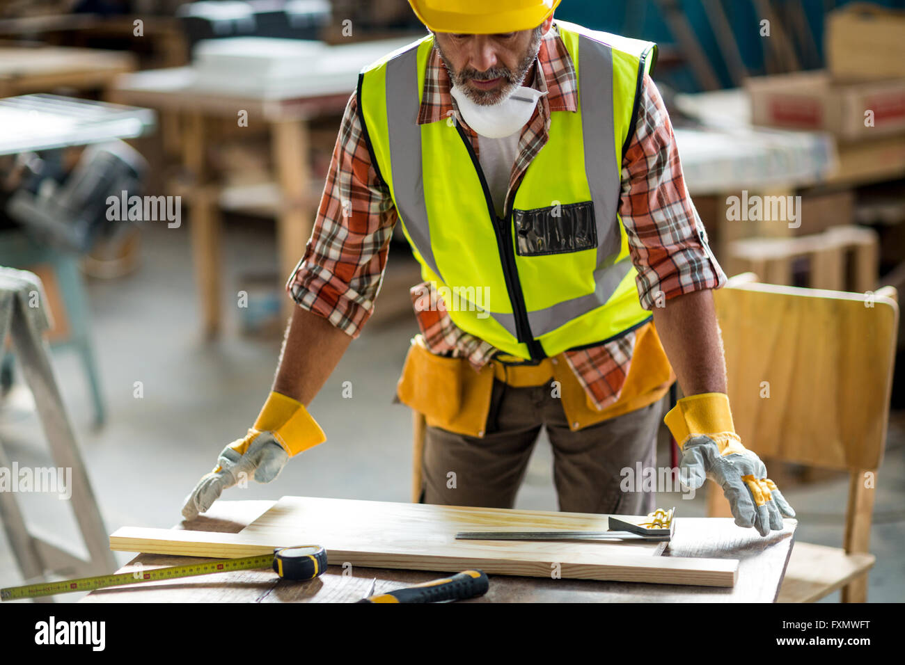 Carpenter measuring wooden plank Stock Photo - Alamy