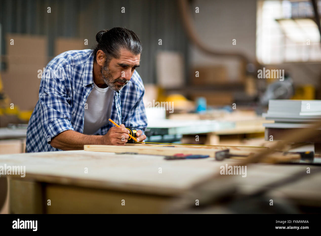 Carpenter marking on wooden plank with pencil Stock Photo - Alamy