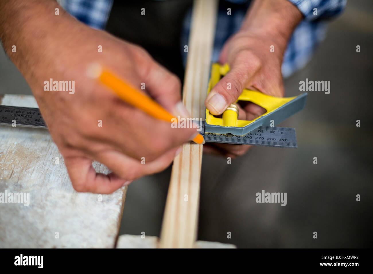 Carpenter marking on wooden plank with pencil Stock Photo - Alamy