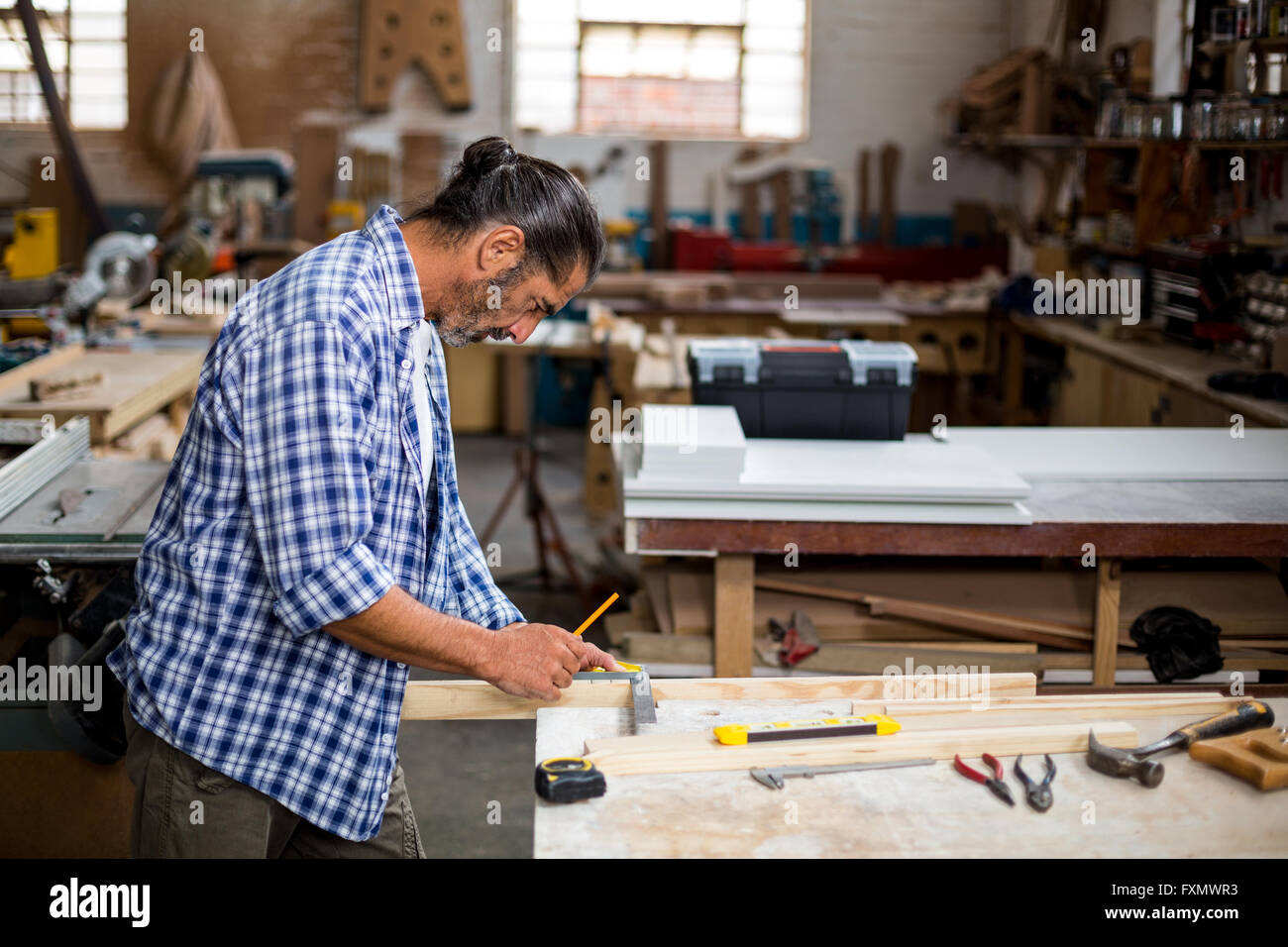 Carpenter marking on wooden plank with pencil Stock Photo - Alamy
