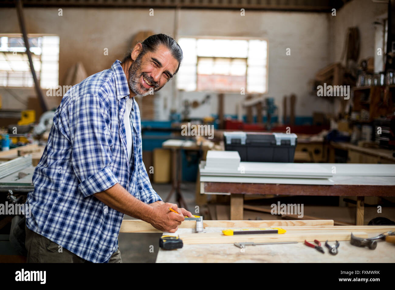 Carpenter marking on wooden plank with pencil Stock Photo - Alamy