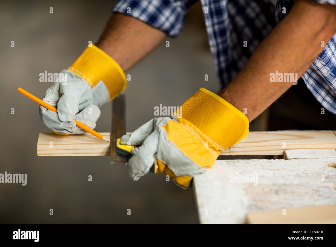 Carpenter marking on wooden plank with pencil Stock Photo - Alamy