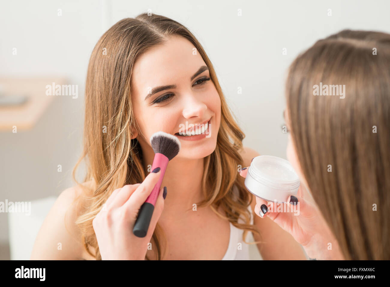 Delighted girls doing make up Stock Photo - Alamy