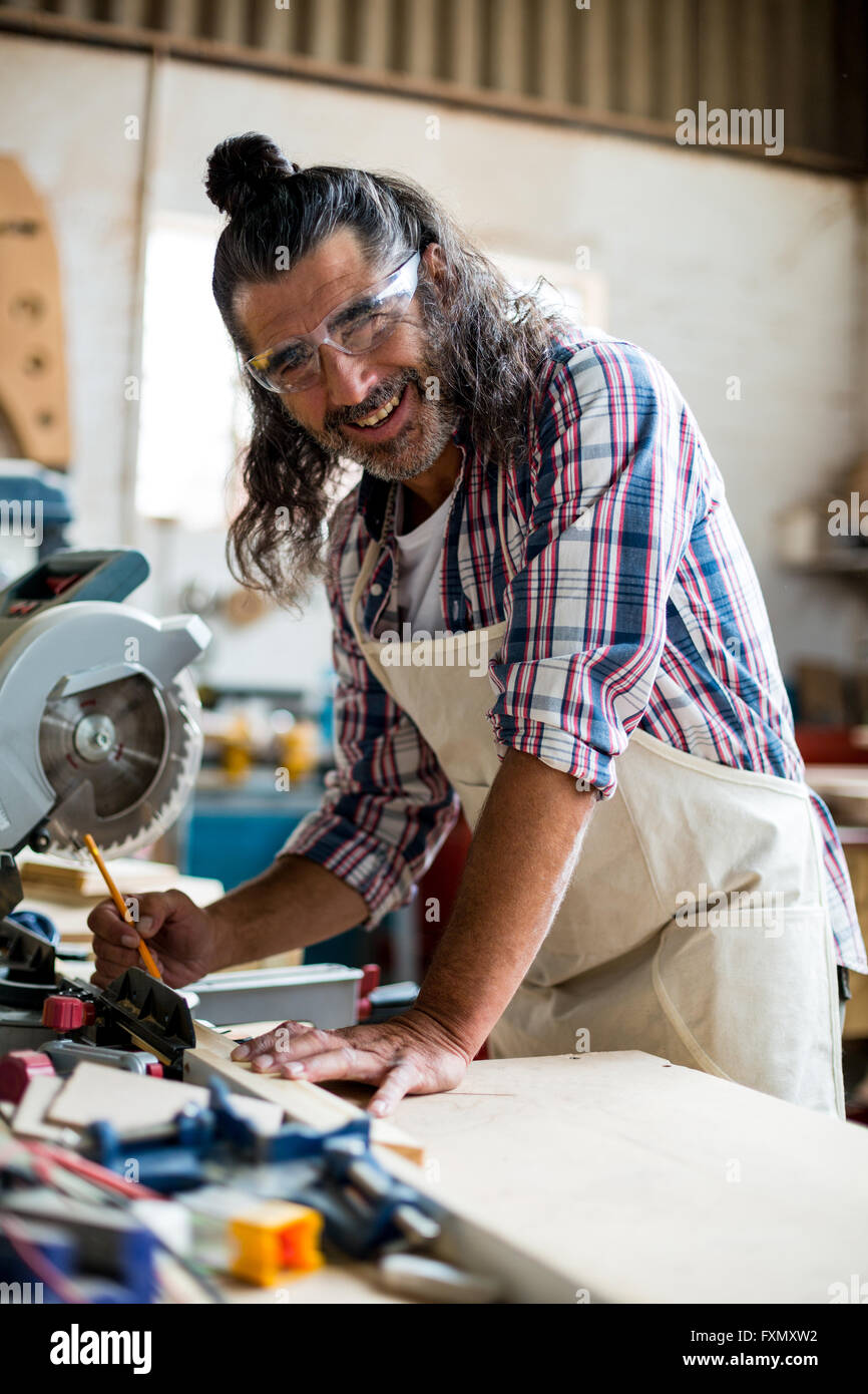 Carpenter measuring wooden plank Stock Photo - Alamy