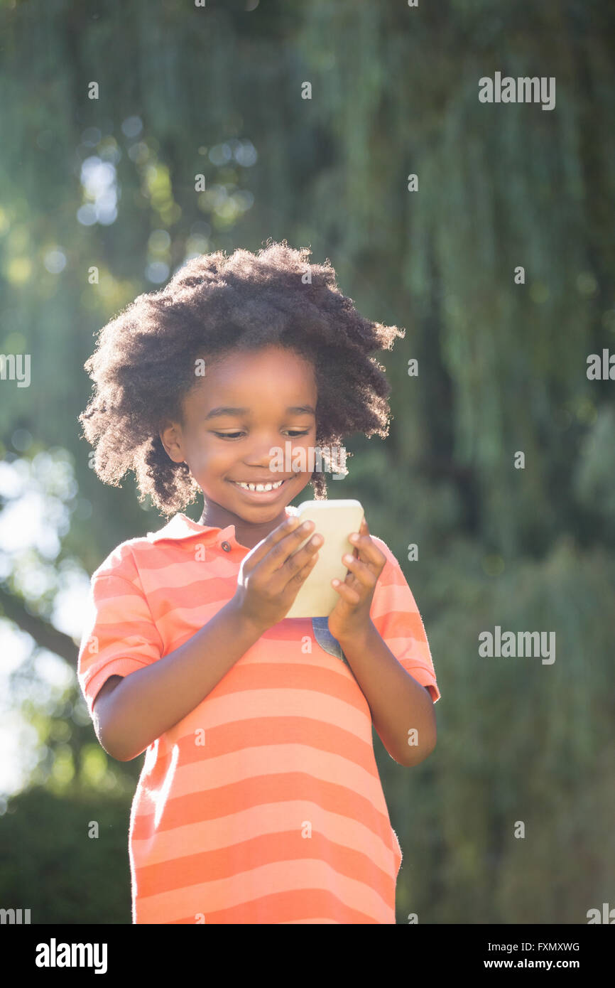 Little boy texting in the park Stock Photo - Alamy