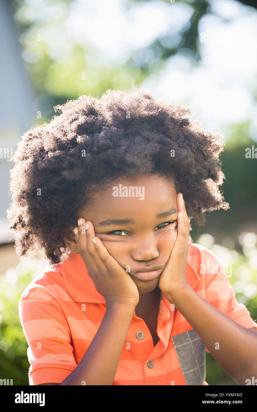 Boy feels sad in a park Stock Photo - Alamy