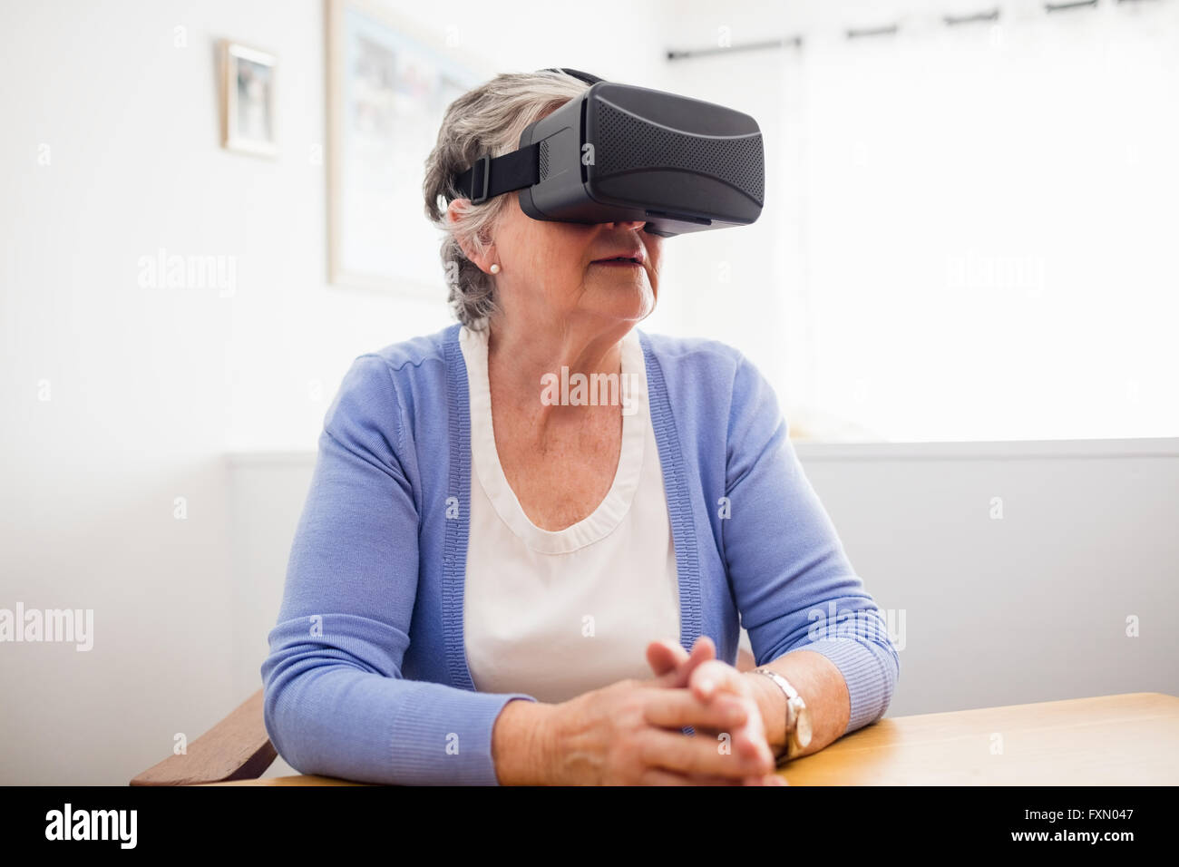Senior woman using an oculus rift Stock Photo - Alamy