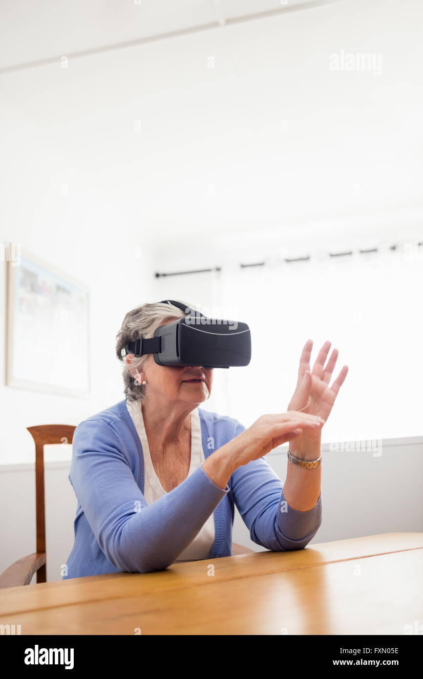 Senior woman using an oculus rift Stock Photo - Alamy